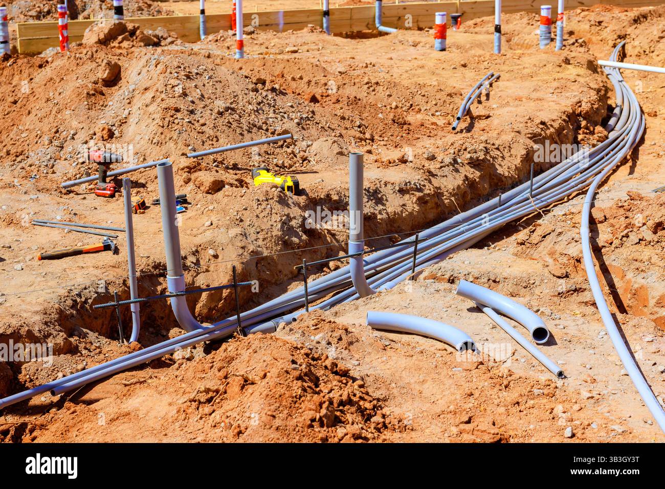 Workers are installing electrical piping at construction site ...