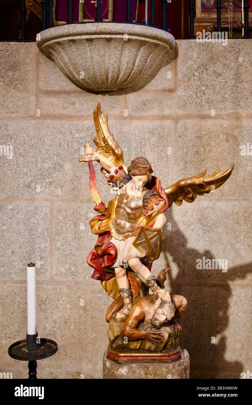 Painted carved wooden statue of Saint Michael Archangel defeating evil ...