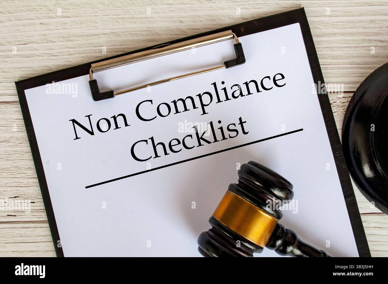 Top view of Non Compliance Checklist text on clipboard with gavel on ...