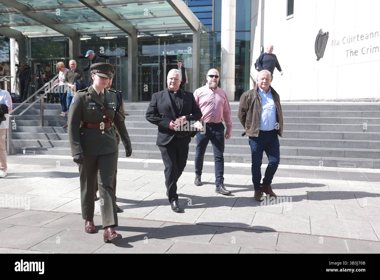 Father Paul Murphy (second left) is accompanied by his two brothers ...