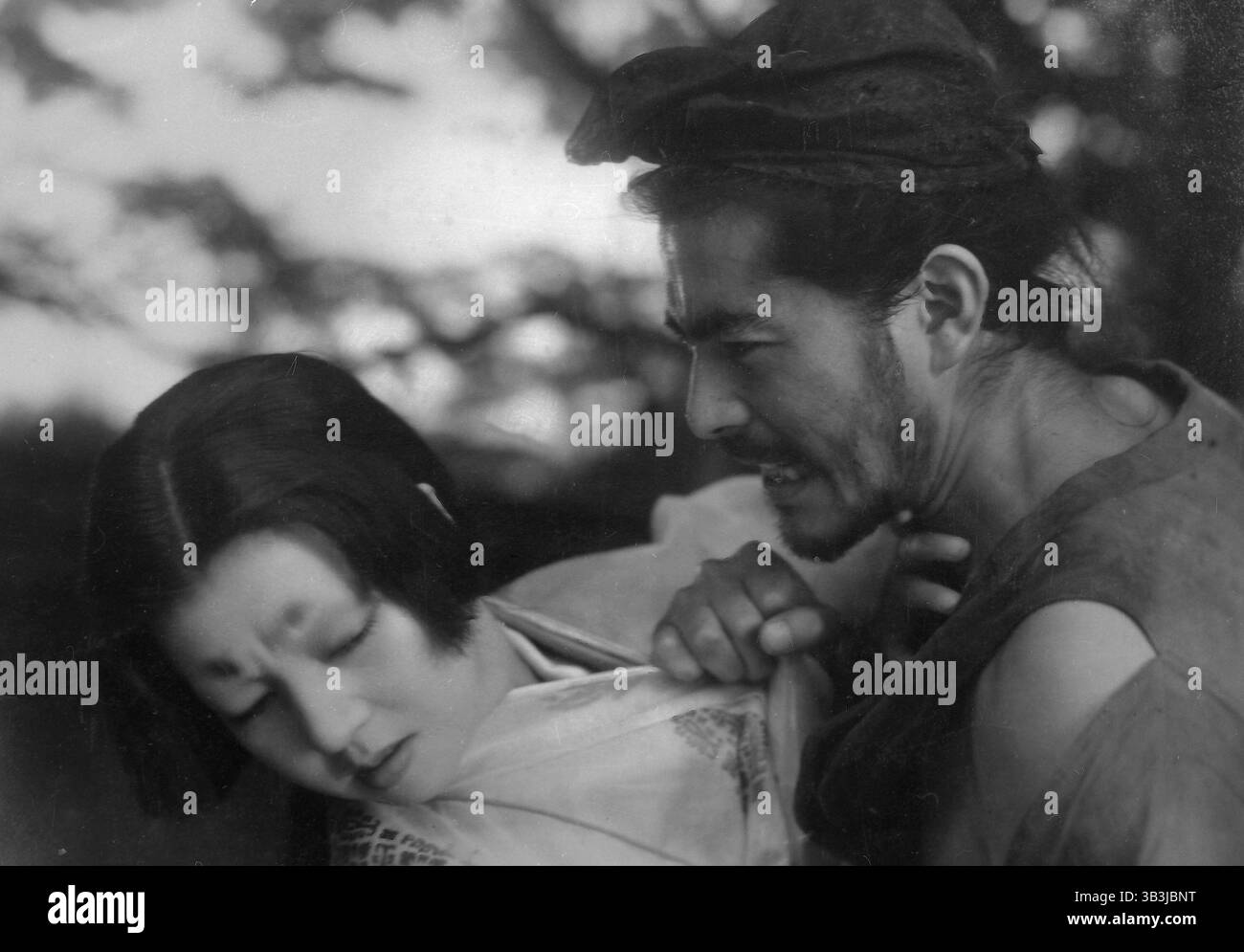 Actors Toshiro Mifune and Machiko Kyo in a scene from the movie Rasho ...