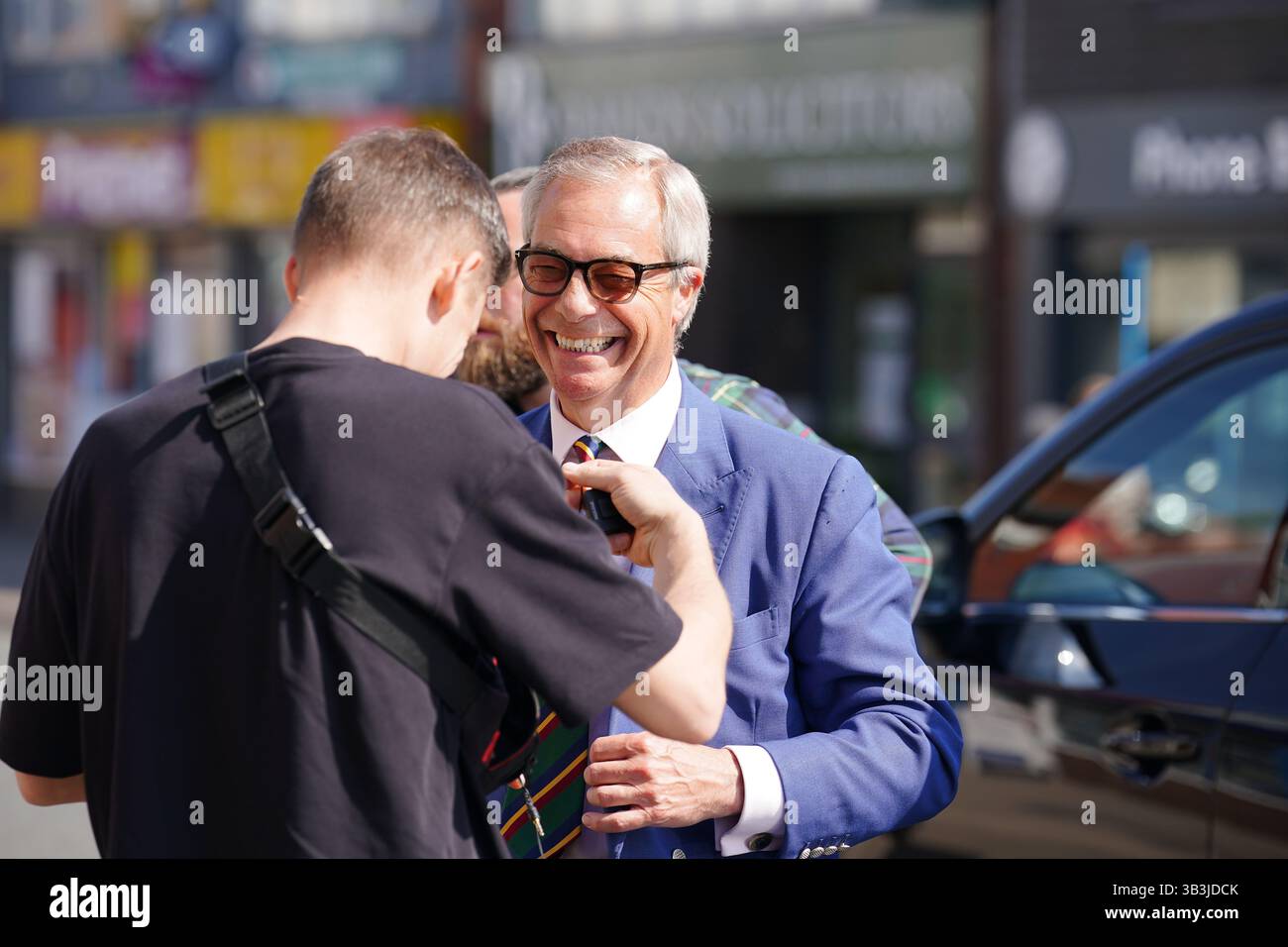 Reform UK party leader Nigel Farage speaks to a member of the public ...