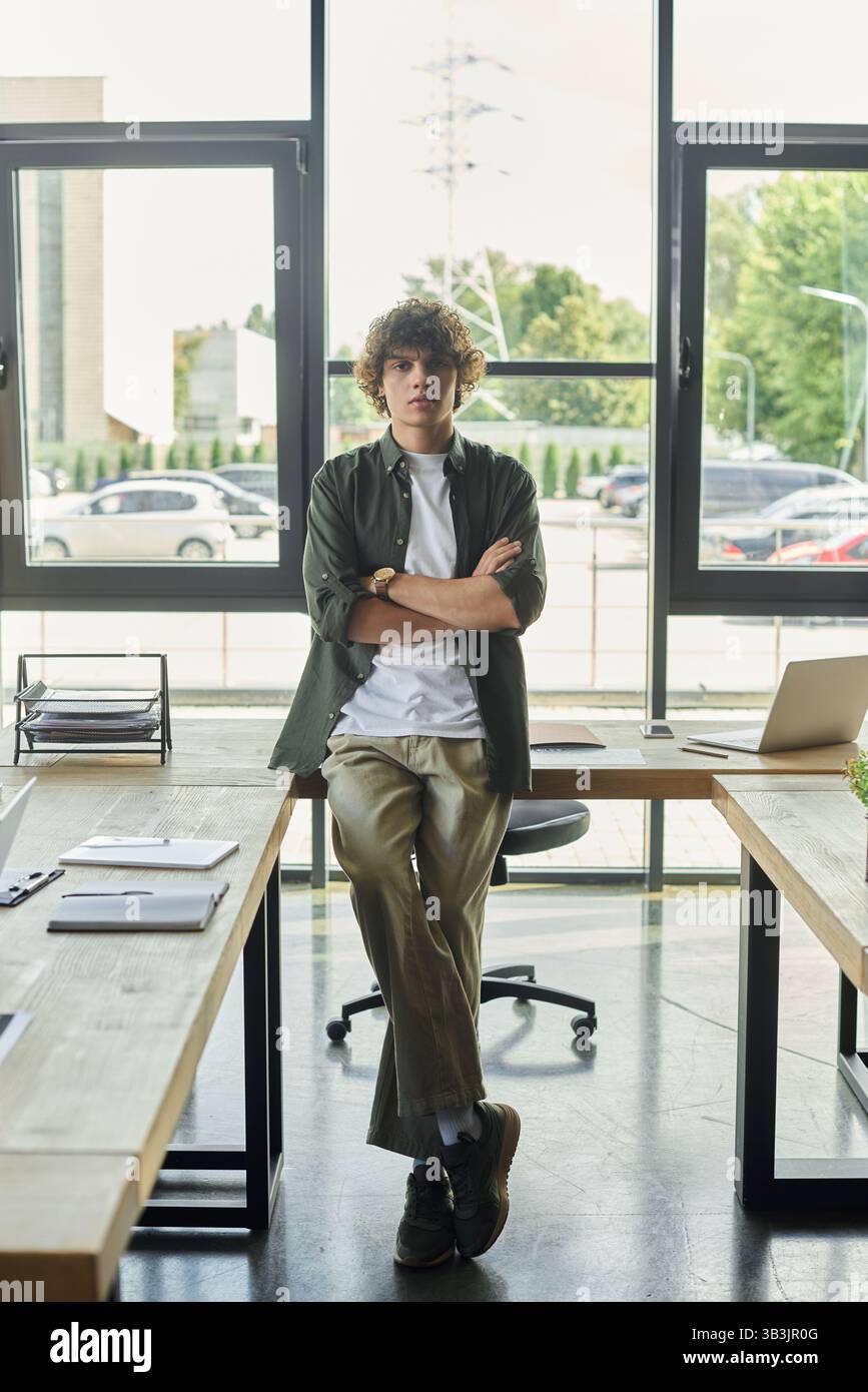 A dedicated worker poses with arms crossed in a stylish, bright office ...