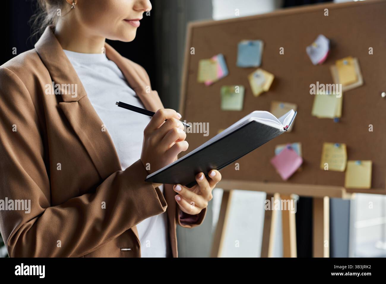 Individual jotting down notes in a professional setting surrounded by ...