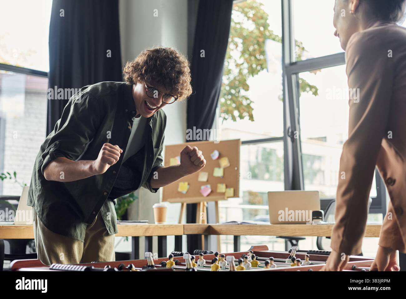 Colleagues express excitement and joy as they engage in a competitive ...