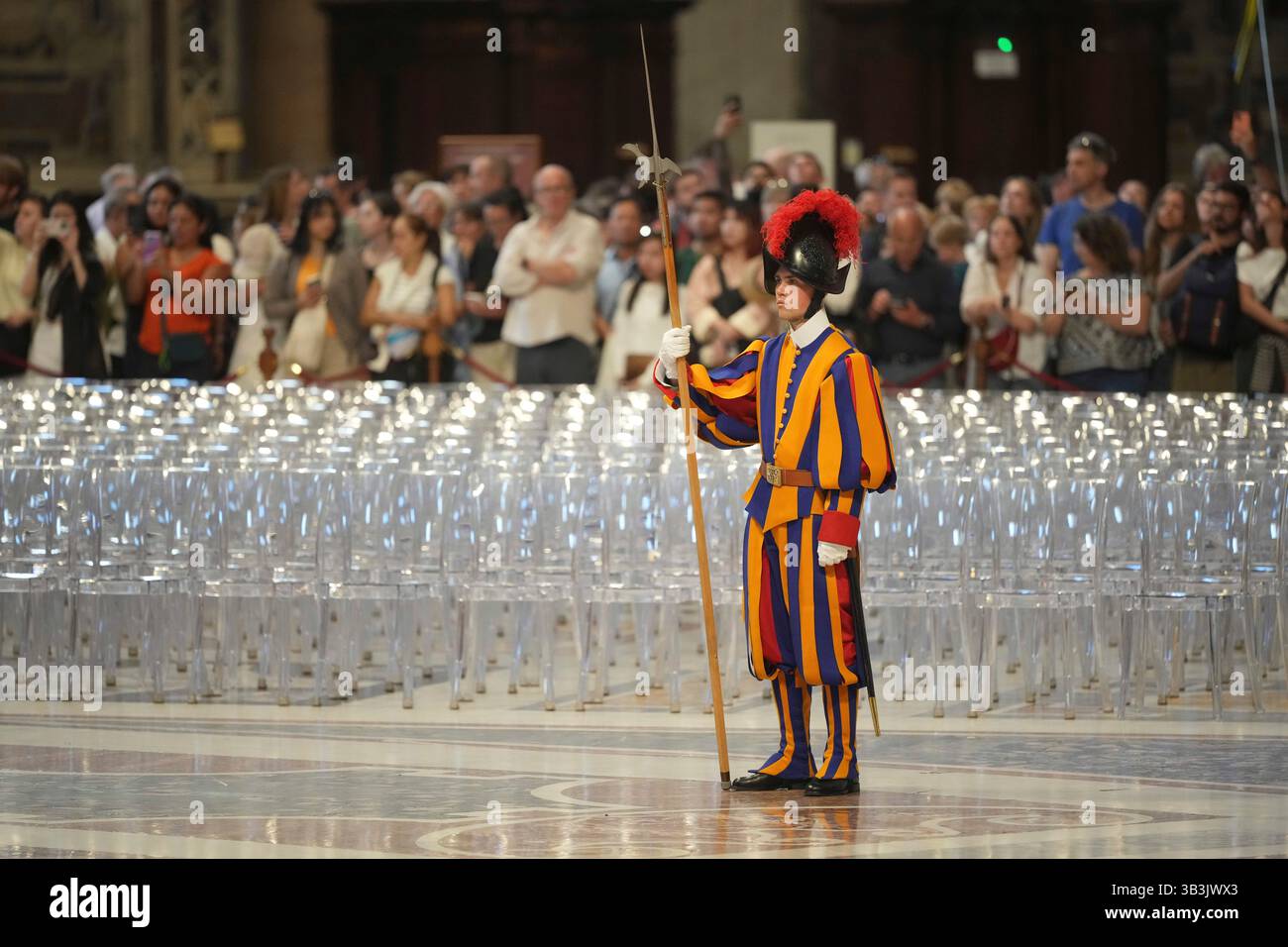A Swiss Guard stands prior to a mass on the fourth of nine days of ...
