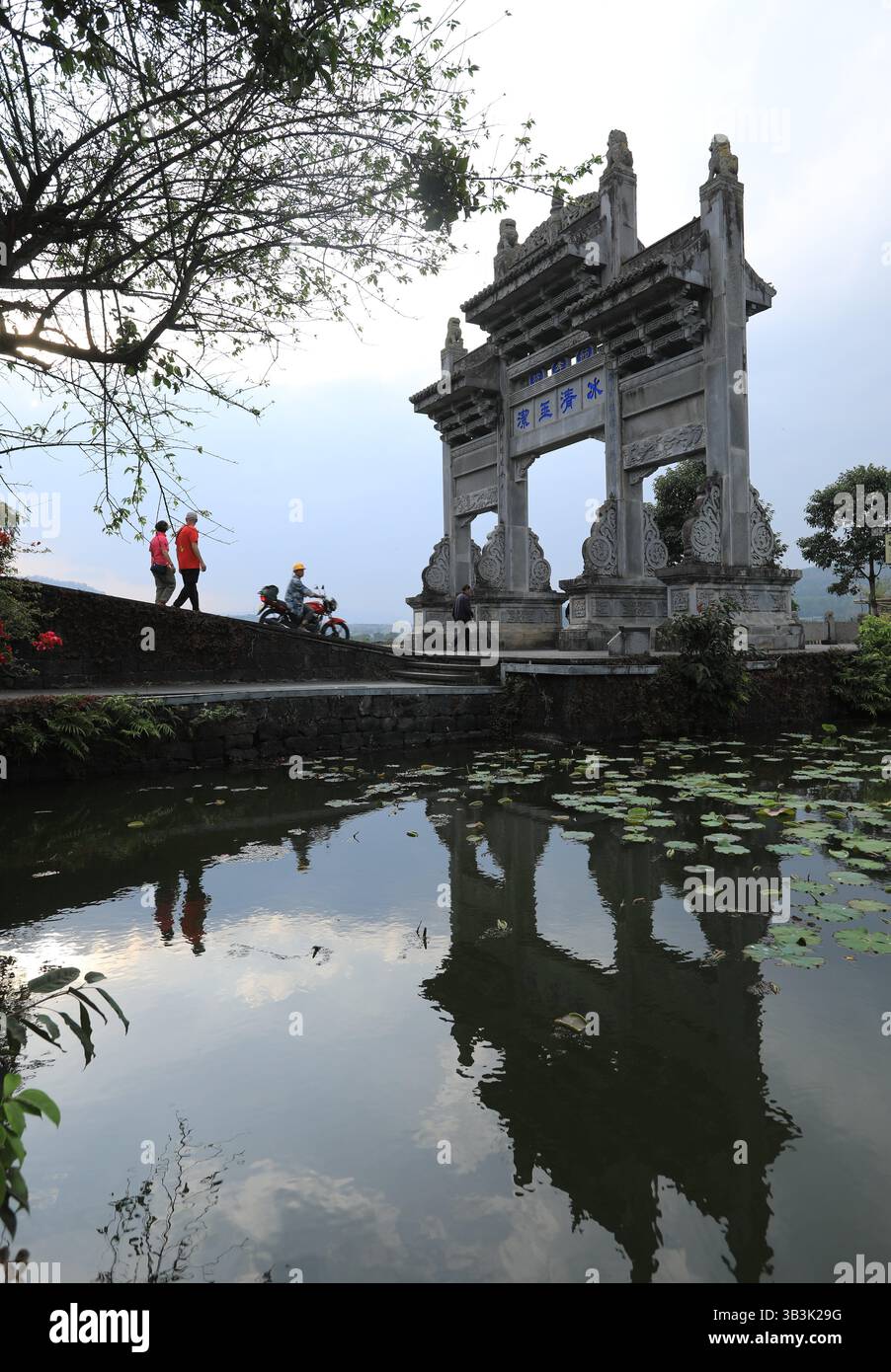 Tengchong, China's Yunnan Province. 23rd Apr, 2025. People pass through ...