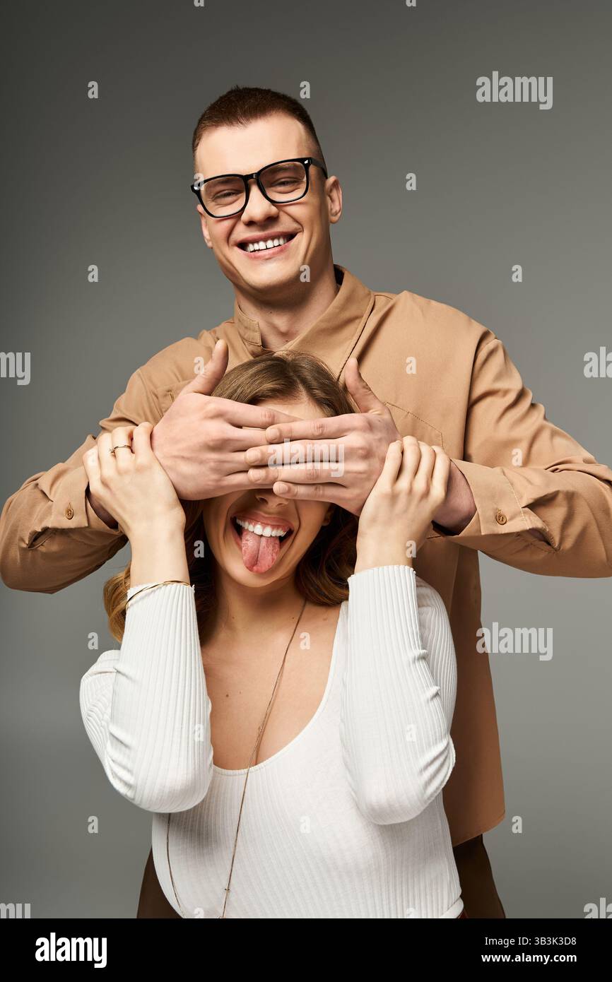 A joyful couple shares love through laughter and playfulness, making a lasting memory Stock ...