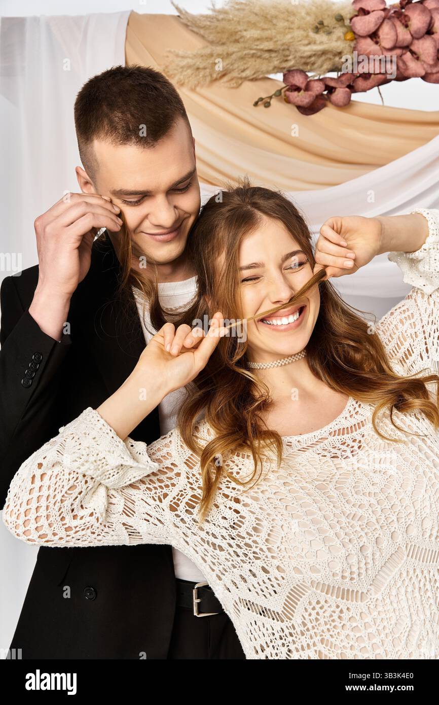 Joyful bride and groom share a playful moment, celebrating their love ...