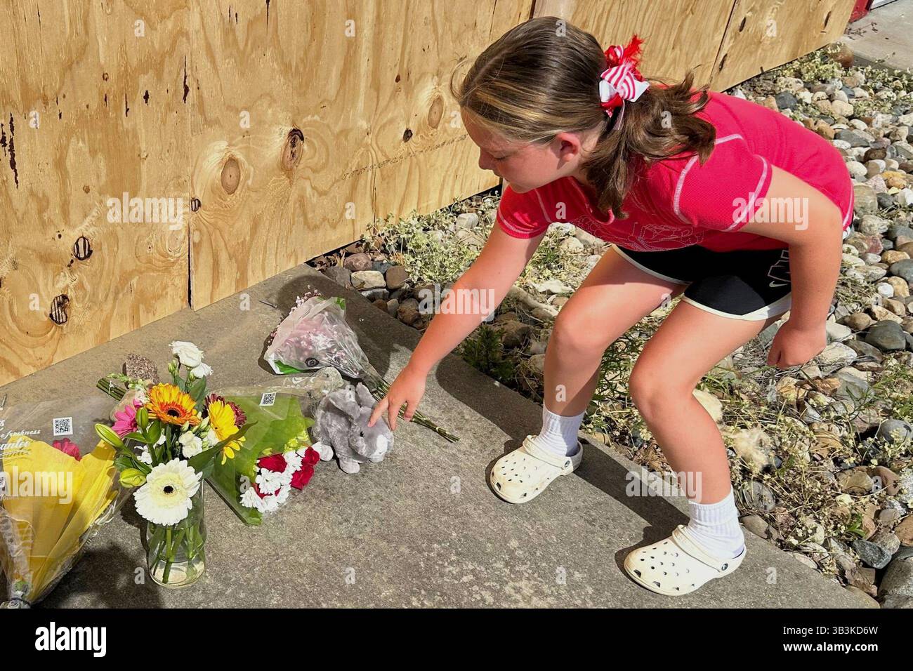 Madison Foster, 10, points out the flowers and plush bunny she left for ...