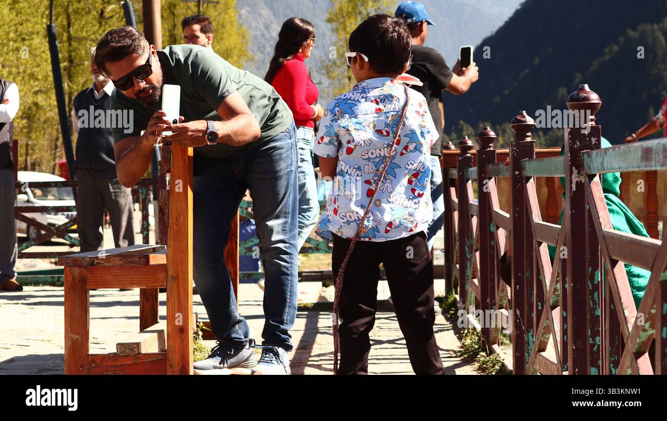 Srinagar, Jammu And Kashmir, India. 28th Apr, 2025. A touridt captures a picture of his son at ...