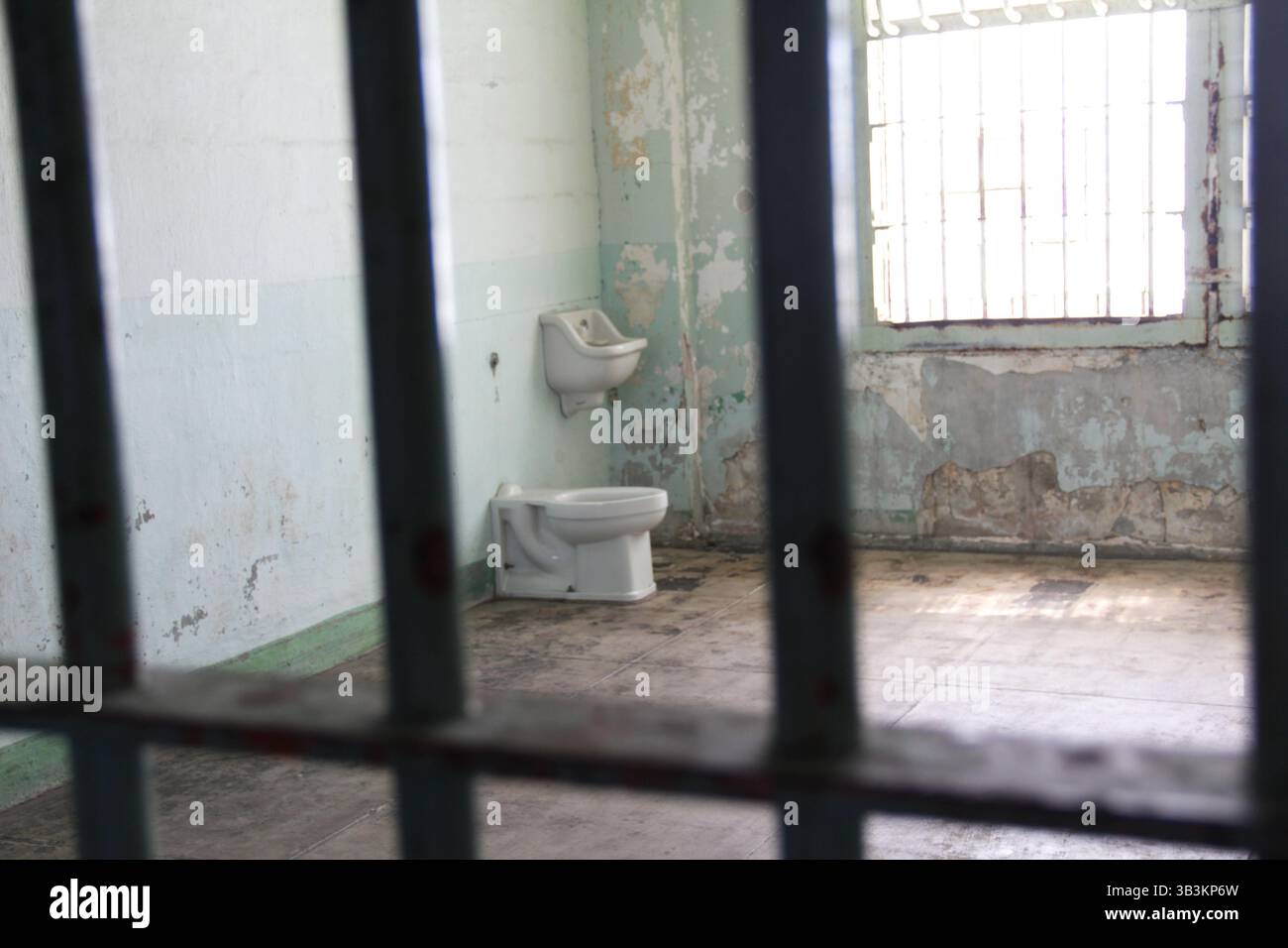 Viewing through the bars of a prison cell on Alcatraz Island, an old ...