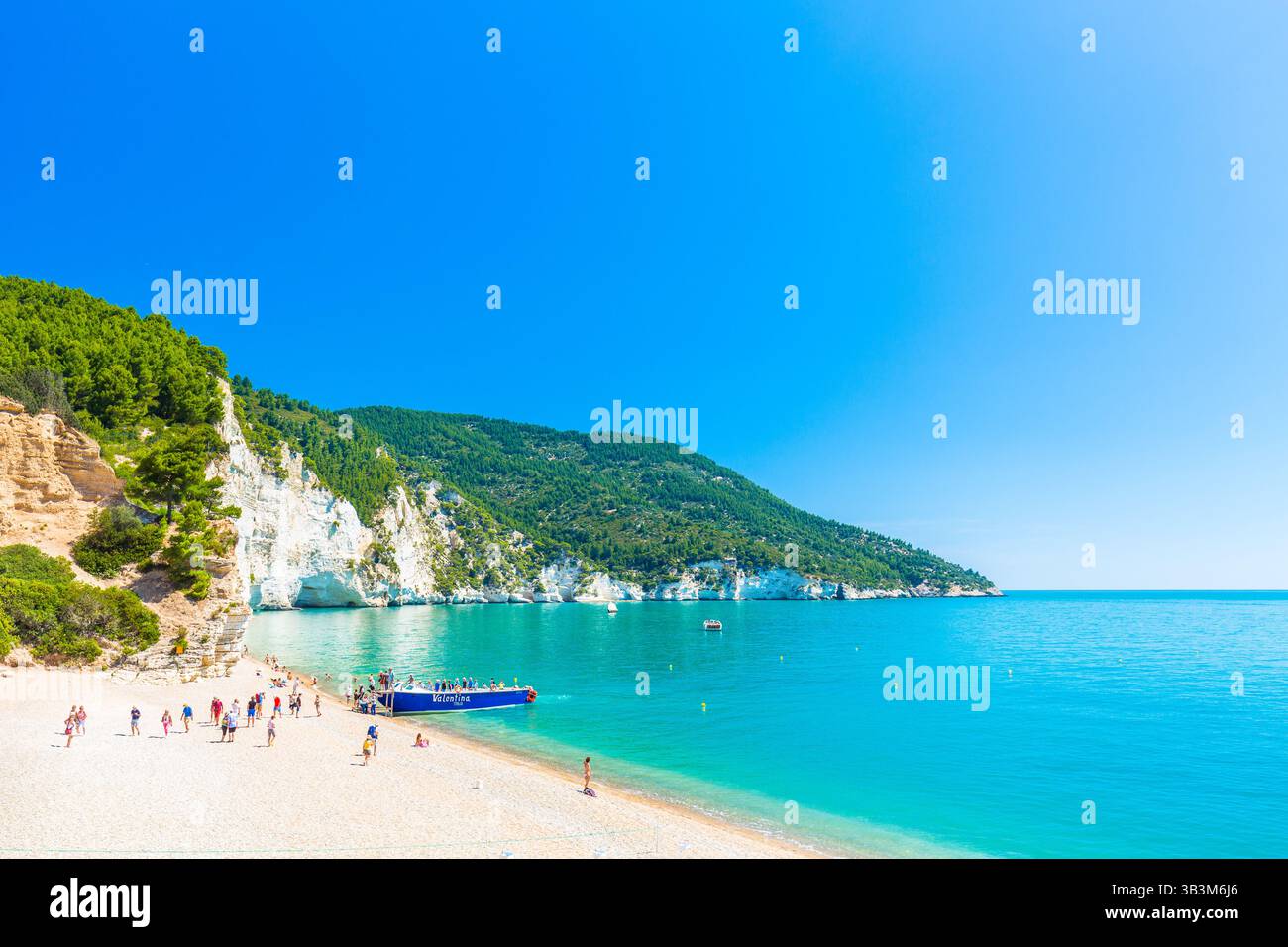 Tourists on the beach of Vignanotica beach, in Apulia region, north ...