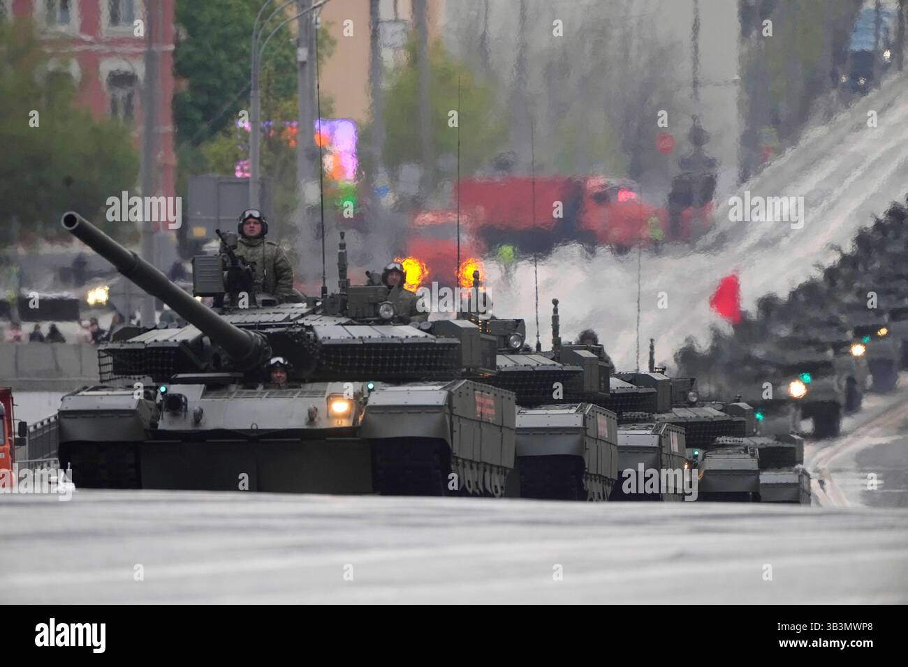 Russian tanks roll along a street toward Red Square to attend a ...