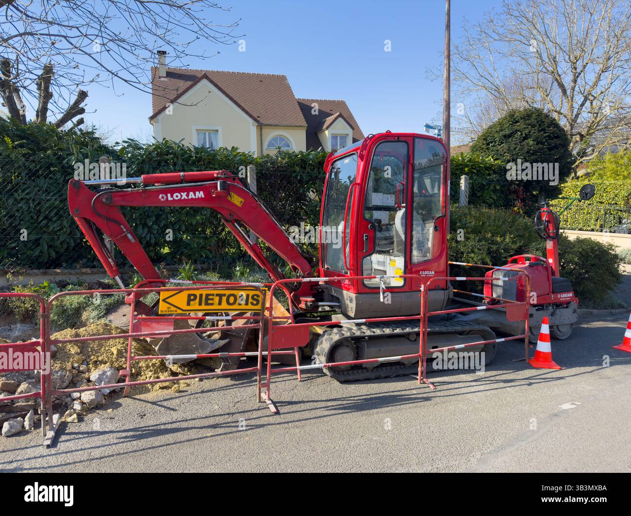 Construction machinery at work on a peaceful residential street in ...
