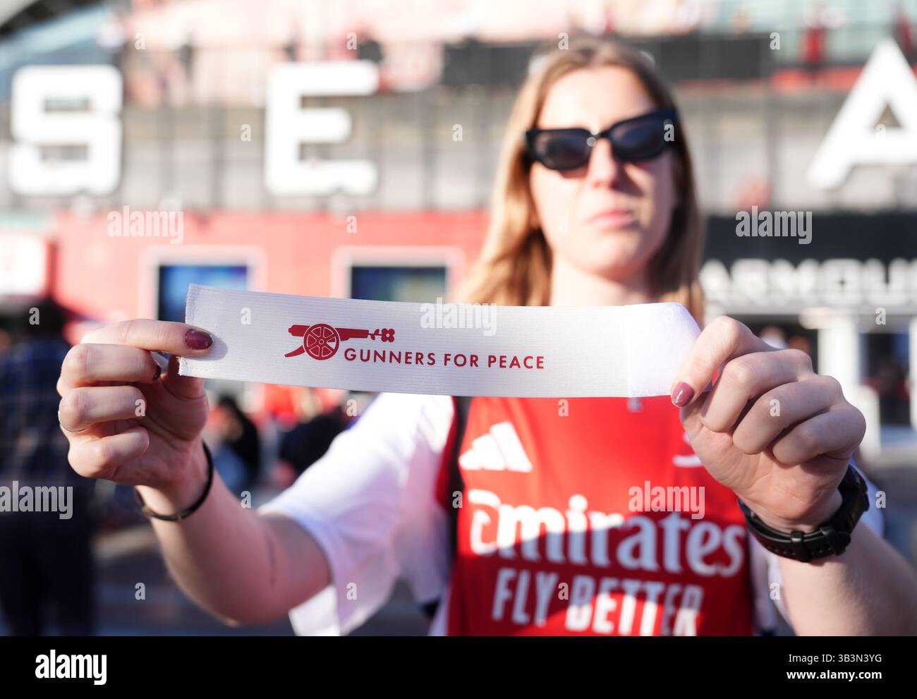 An Arsenal fan holds up a Gunners For Peace banner protesting Visit ...