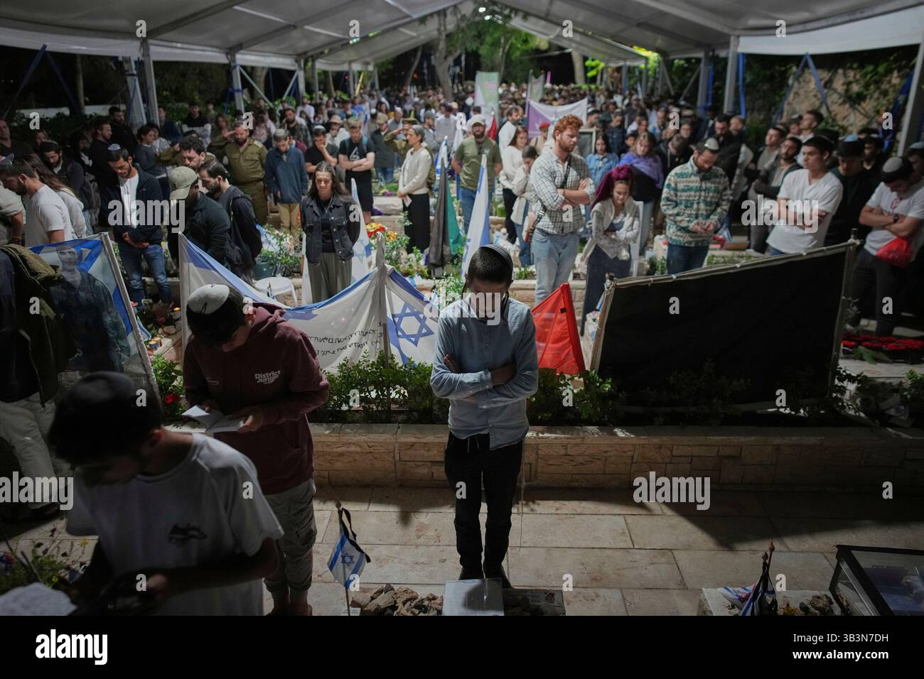 People stands still to observe a minute of silence as a siren sound ...