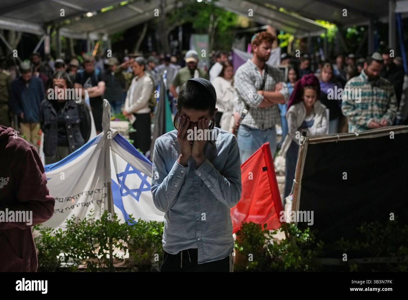 People stands still to observe a minute of silence as a siren sound ...