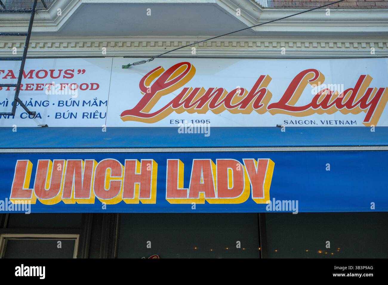 The colourful sign & awning for the Lunch Lady restaurant along ...