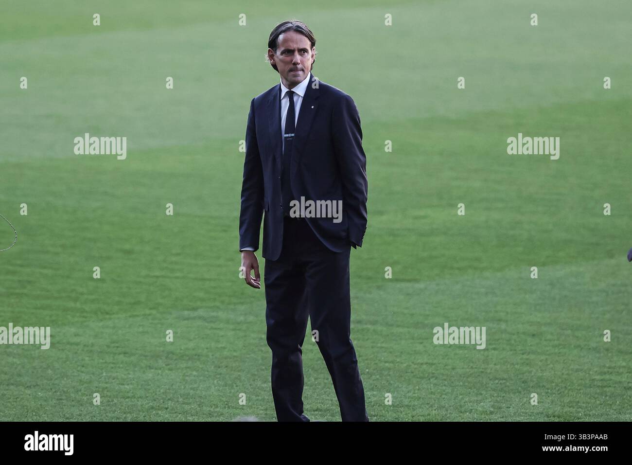 Simone Inzaghi, head coach inspects the pitch ahead during the training ...