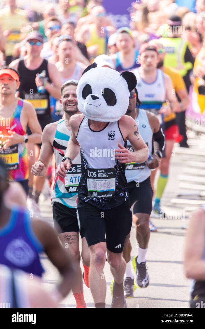 Matt Webster competing in the 2025 TCS London Marathon, passing through ...