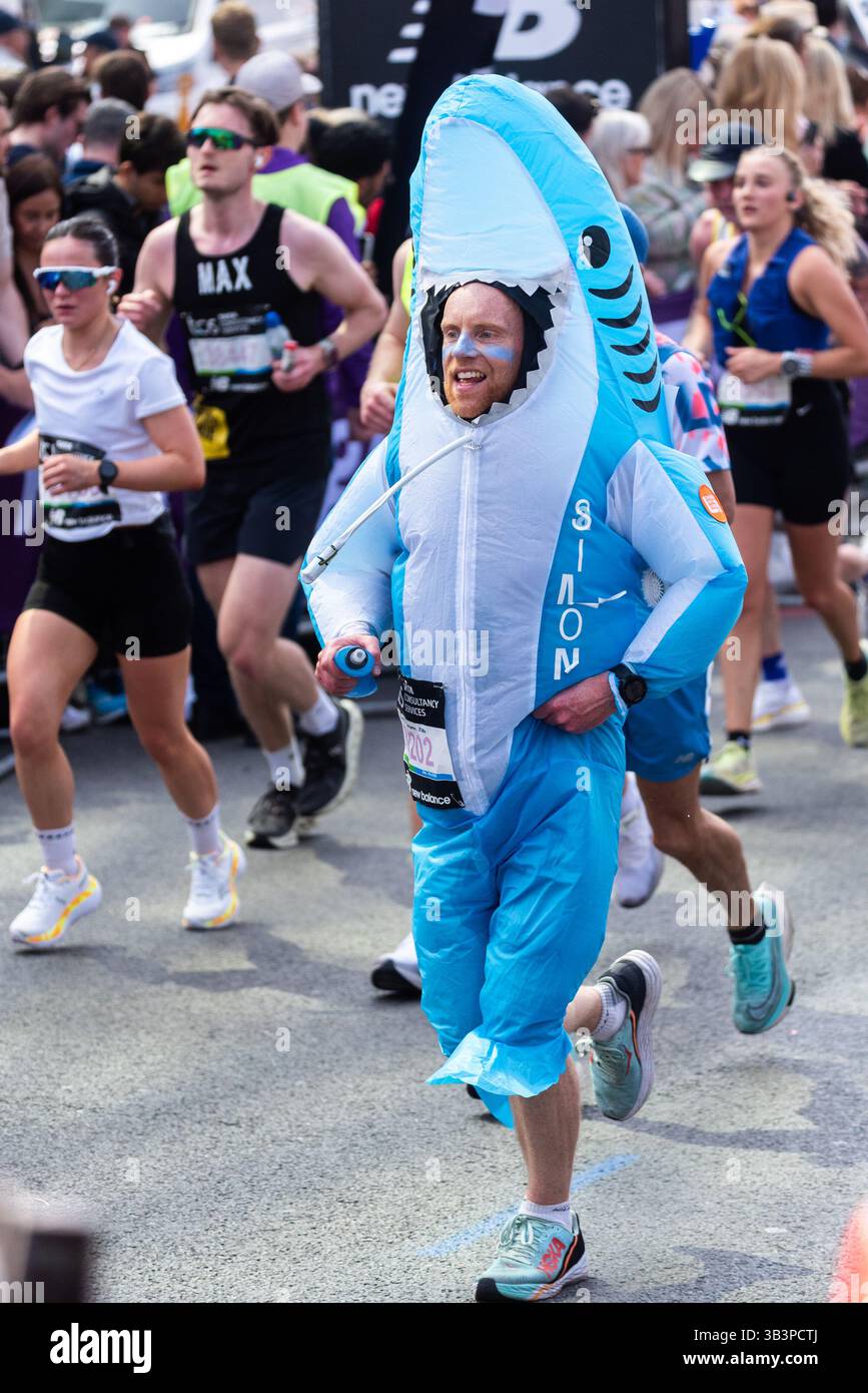 Simon Helyar competing in the 2025 TCS London Marathon, passing through ...