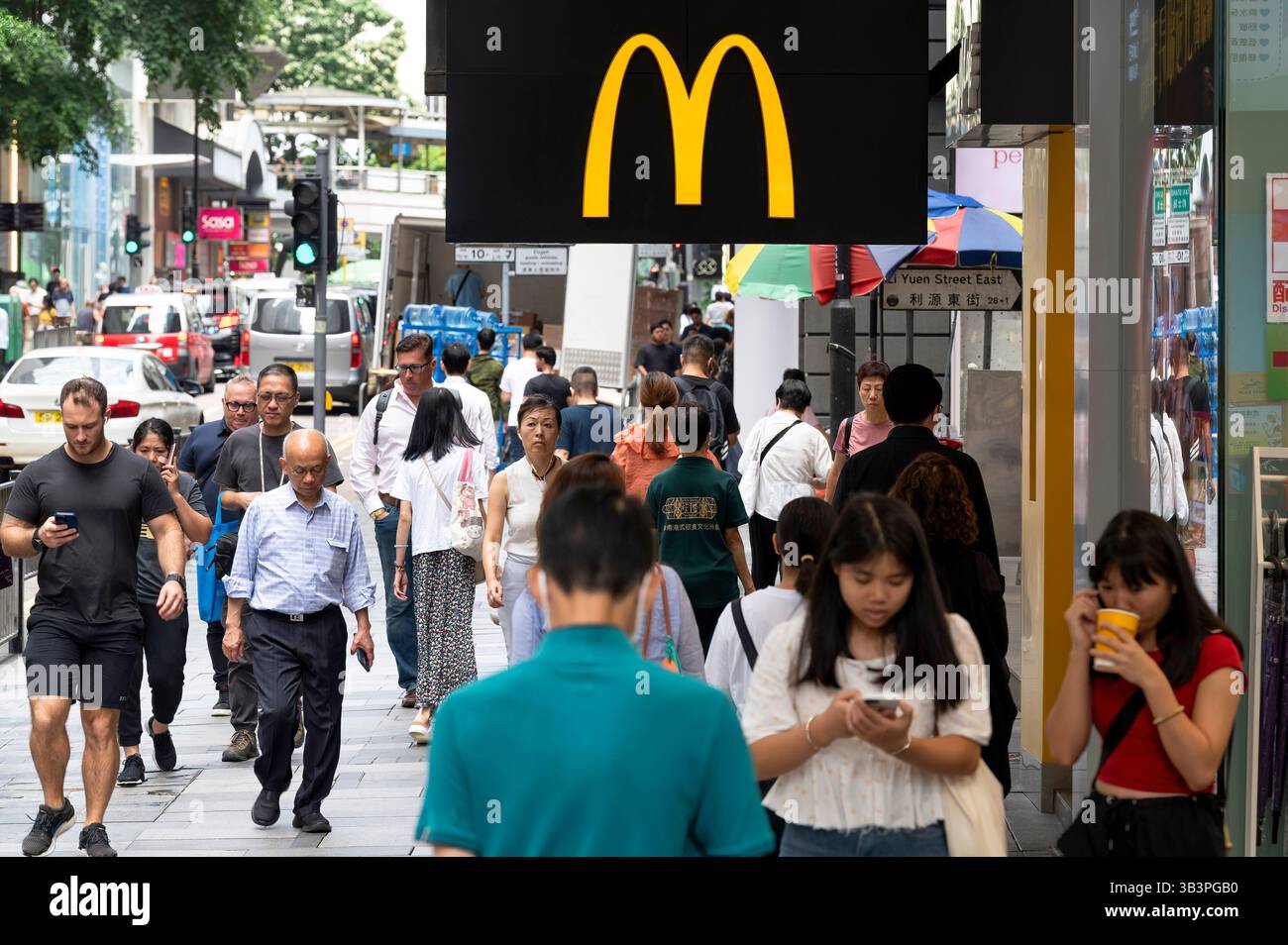 Hong Kong, China. 23rd Aug, 2024. Pedestrians walk past the McDonald's fast-food restaurant and ...