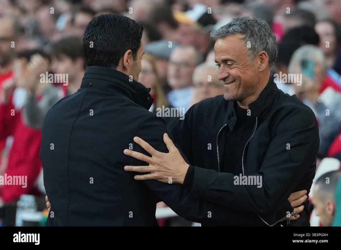 hugs Arsenal's manager Mikel Arteta, greets PSG's head coach Luis ...