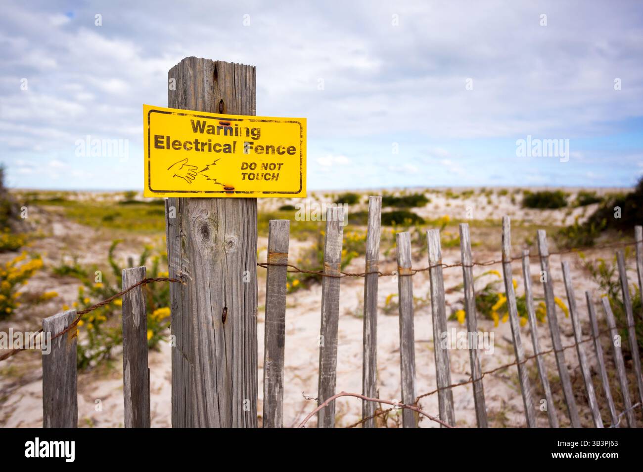 Warning sign and electric fence to protect fragile sand dunes at ...