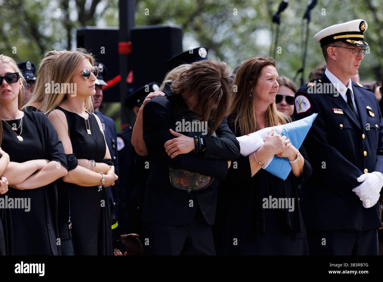 Chicago Fire Department Capt. David Meyer's son, Michael, holds his father's helmet during his ...