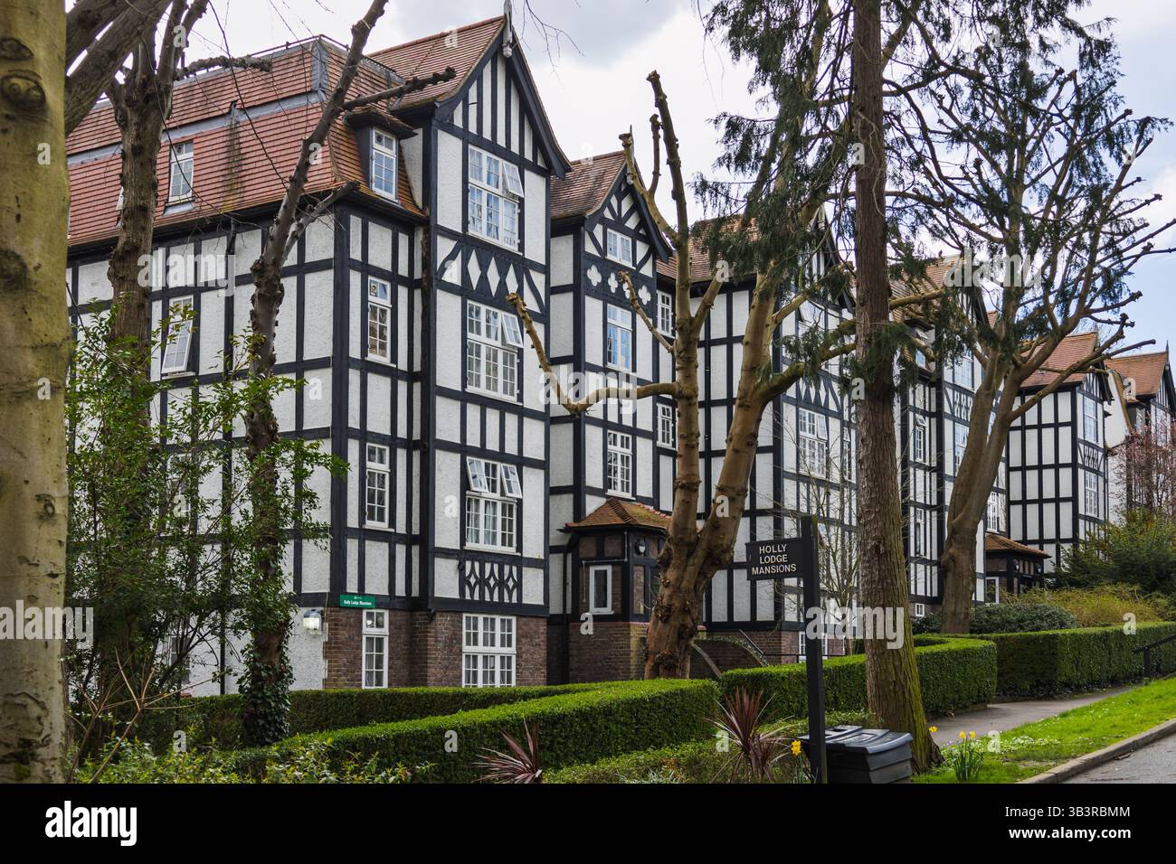 Historic timber framed architecture surrounded by blossoming trees ...