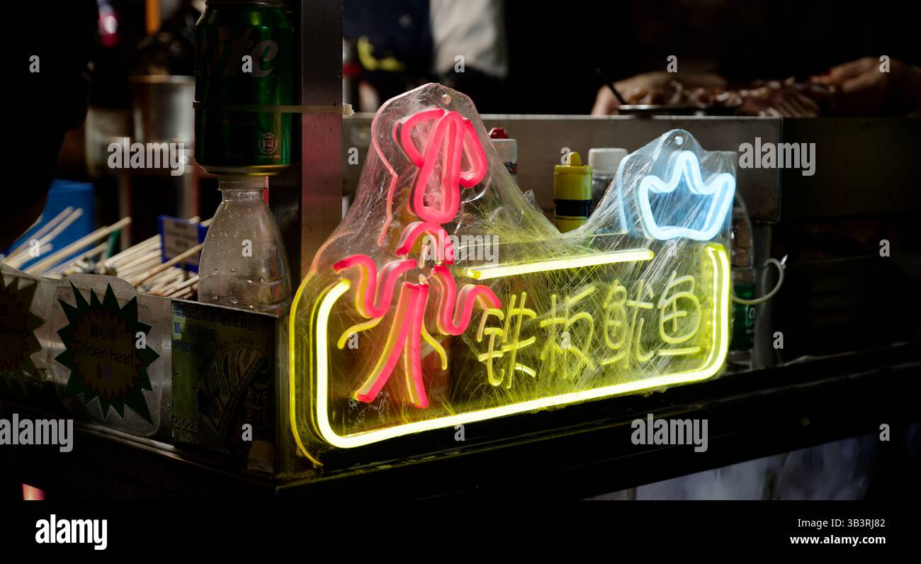 Neon squid sign lights up a sizzling street food stall in Hong Kong’s ...