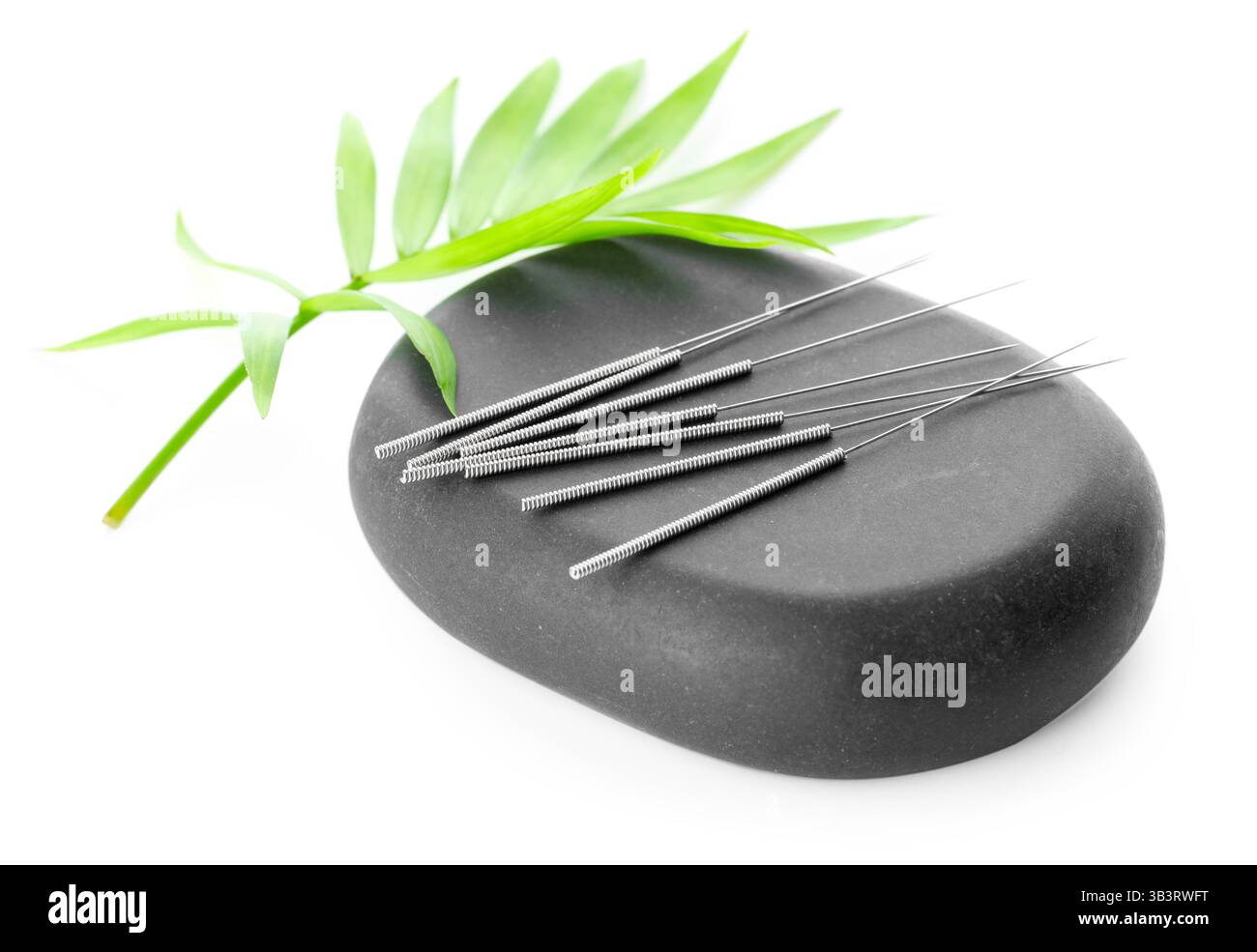 Acupuncture needles, spa stone and leaves isolated on white Stock Photo ...