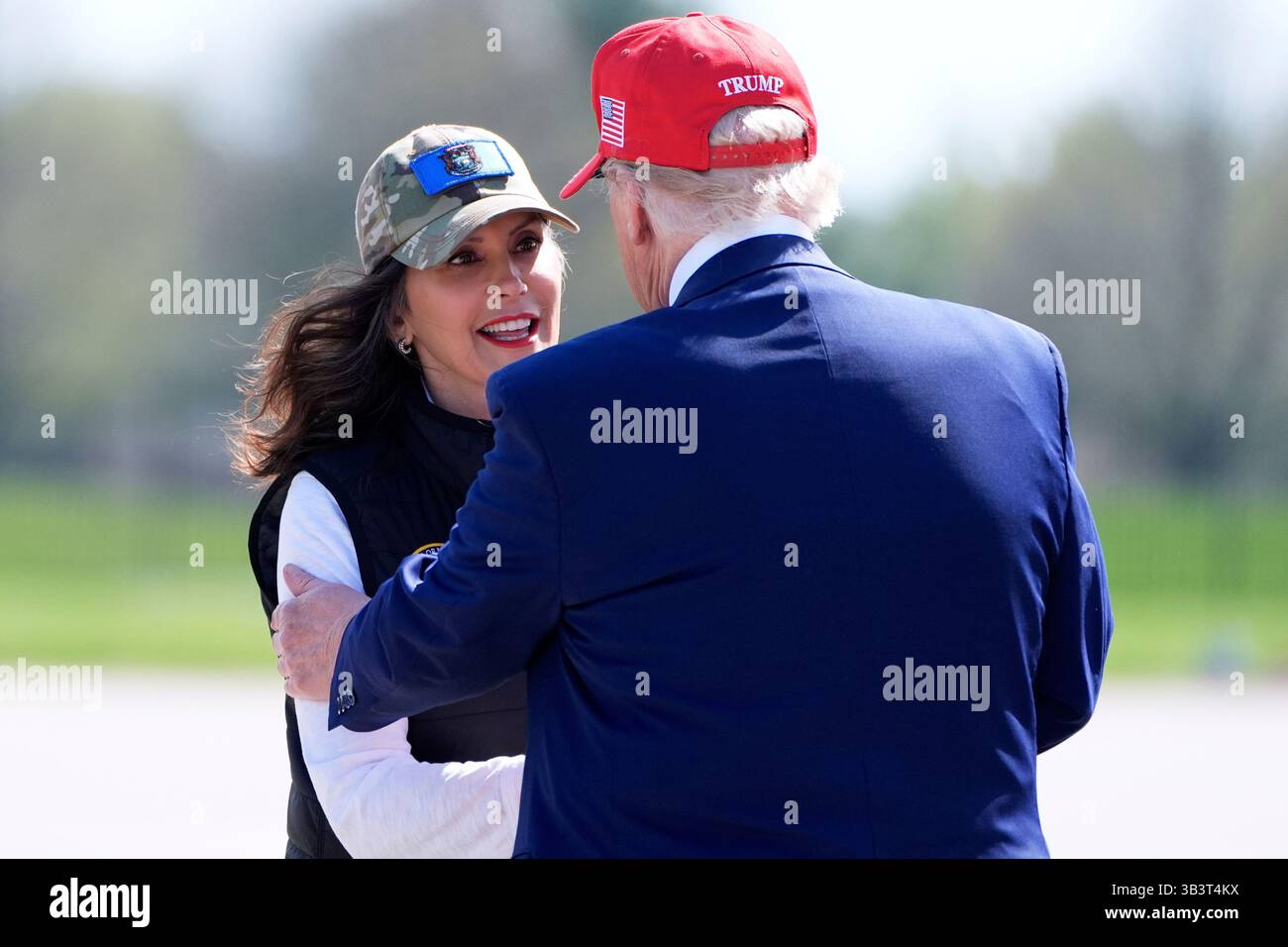 President Donald Trump greets Michigan Gov. Gretchen Whitmer as he arrives on Air Force One at ...