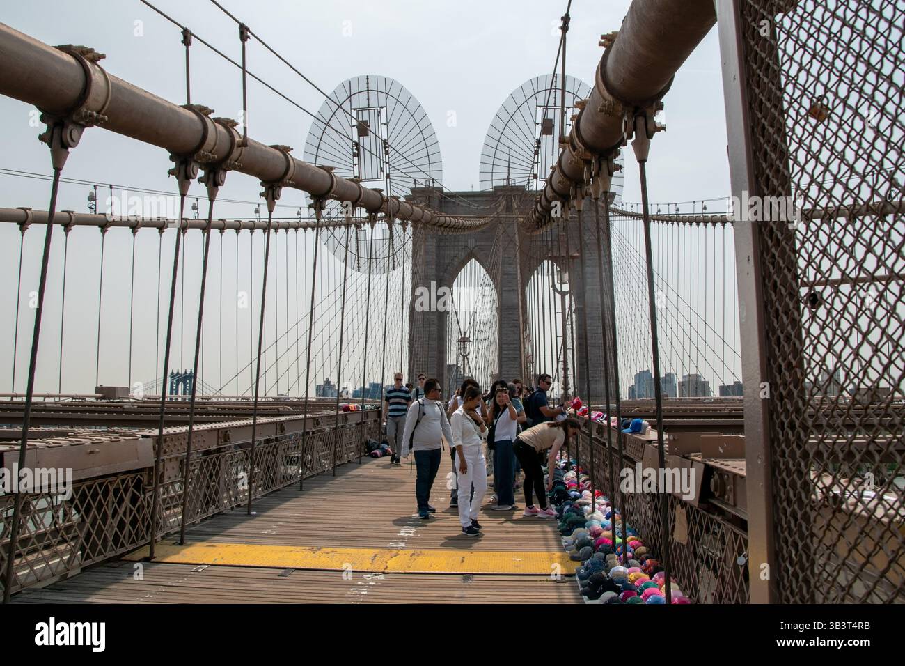 Daily life on Brooklyn Bridge with people walking in New York, tourism ...