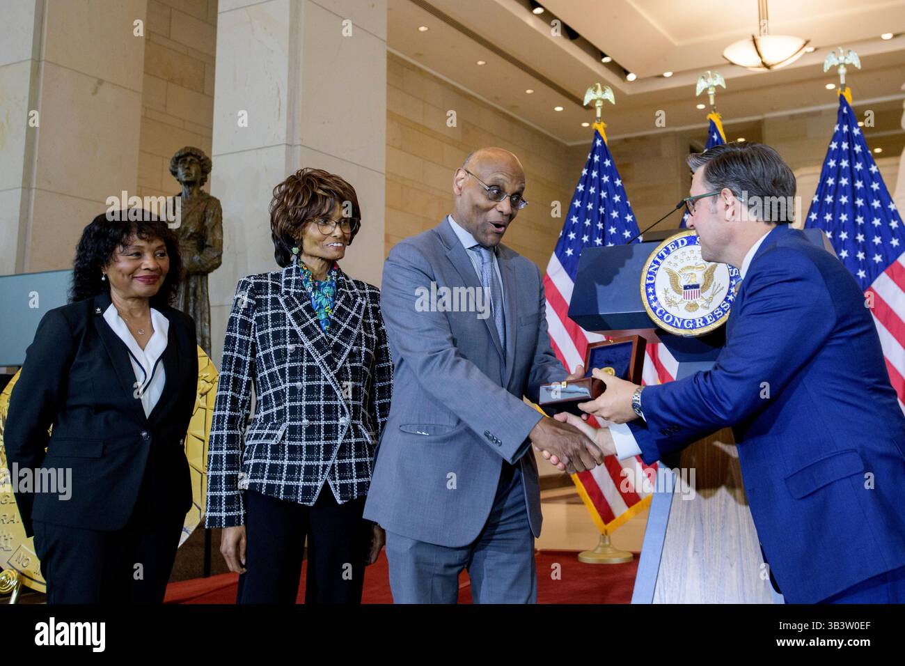 House Speaker Mike Johnson, R-La., right, presents the Congressional ...