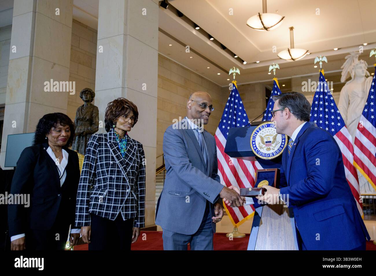House Speaker Mike Johnson, R-La., right, presents the Congressional ...