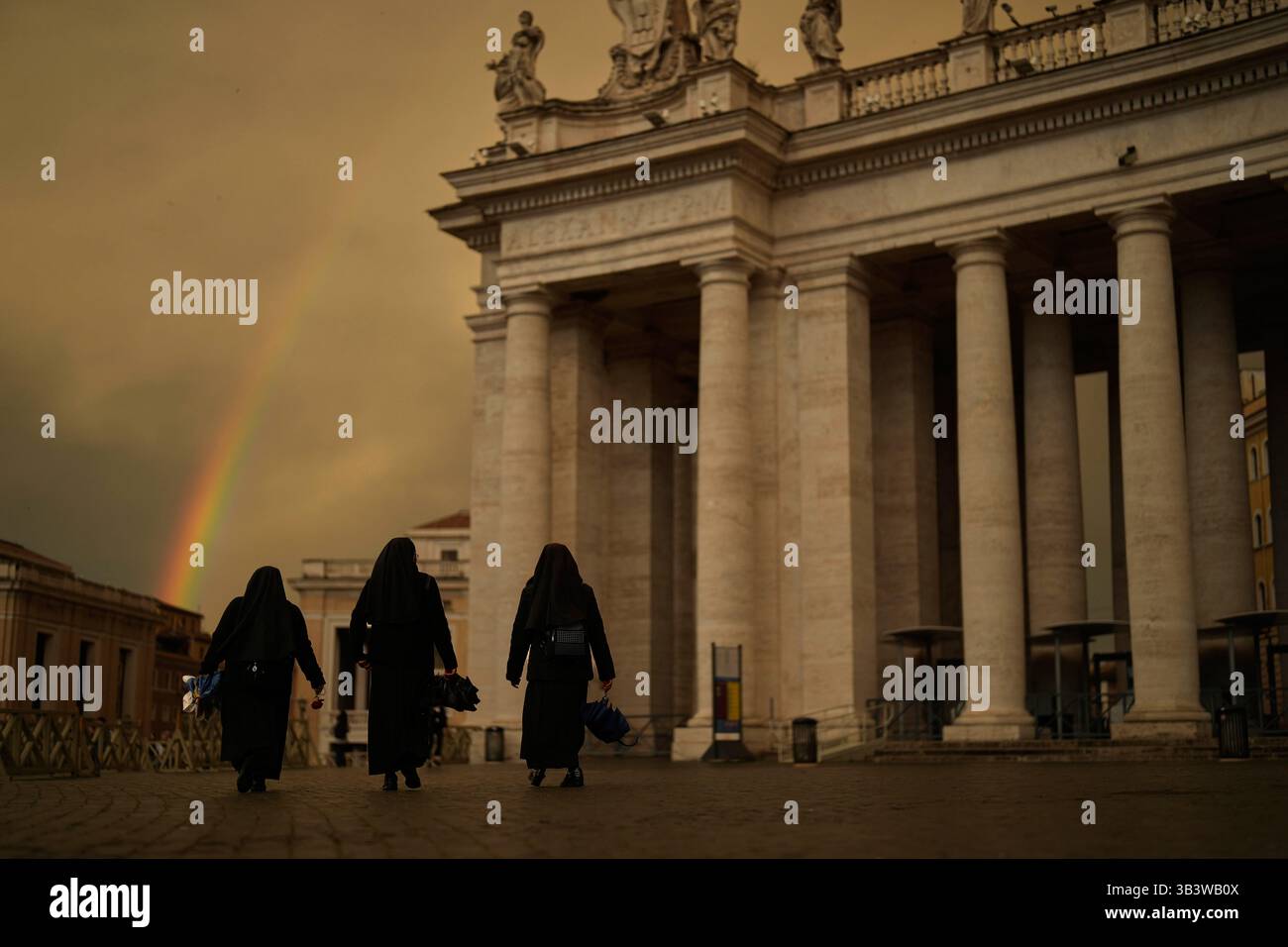 Nuns walk along St. Peter's Square after rain during the fourth of nine ...