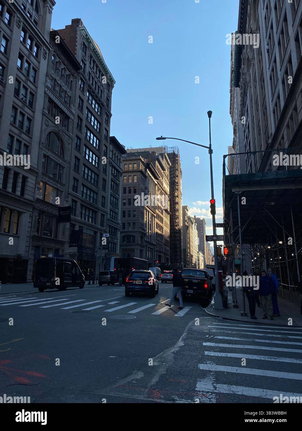 People walk with purpose through a busy Manhattan intersection filled ...