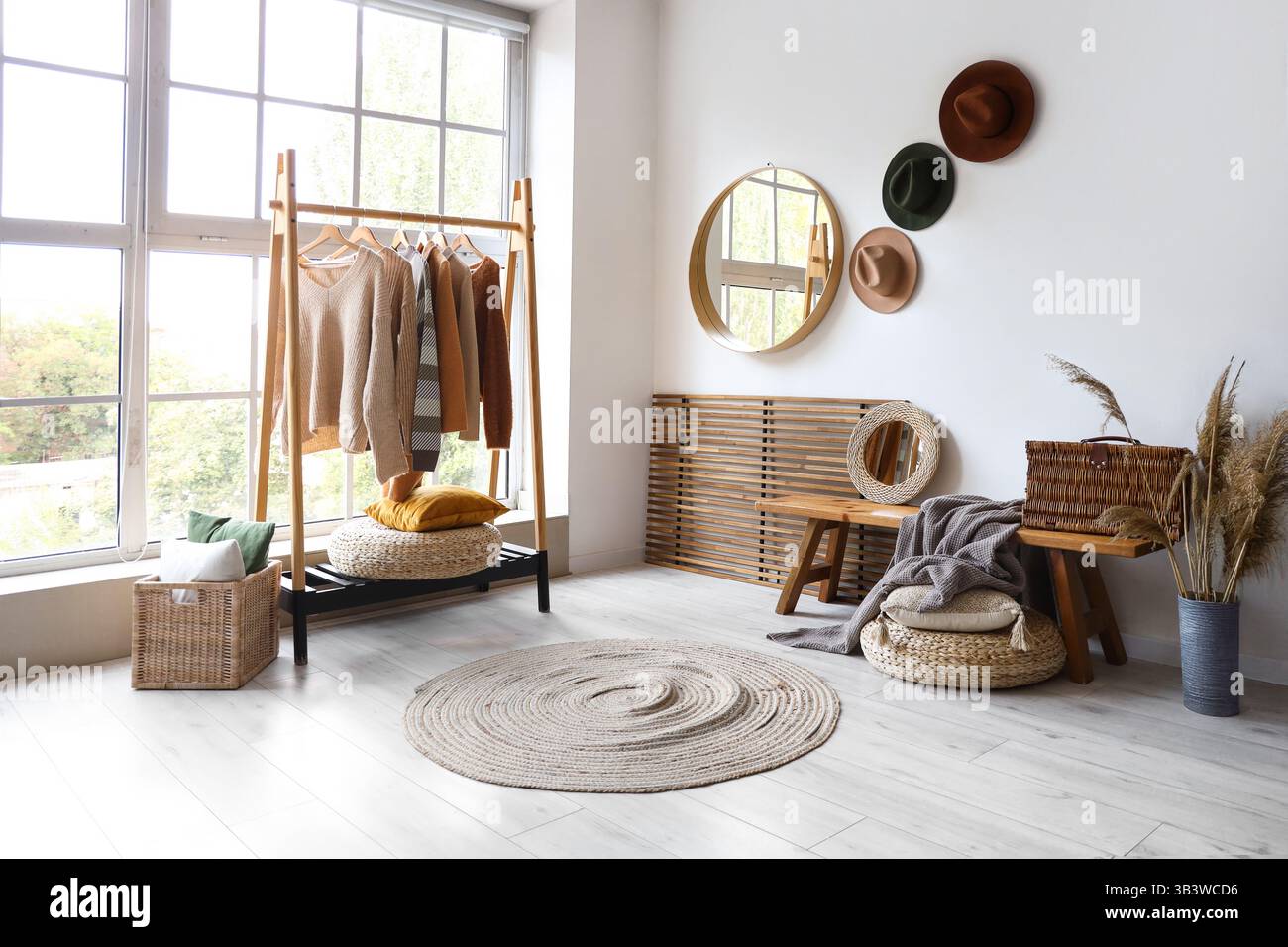 Interior of dressing room with wooden bench, clothes rack and mirrors ...