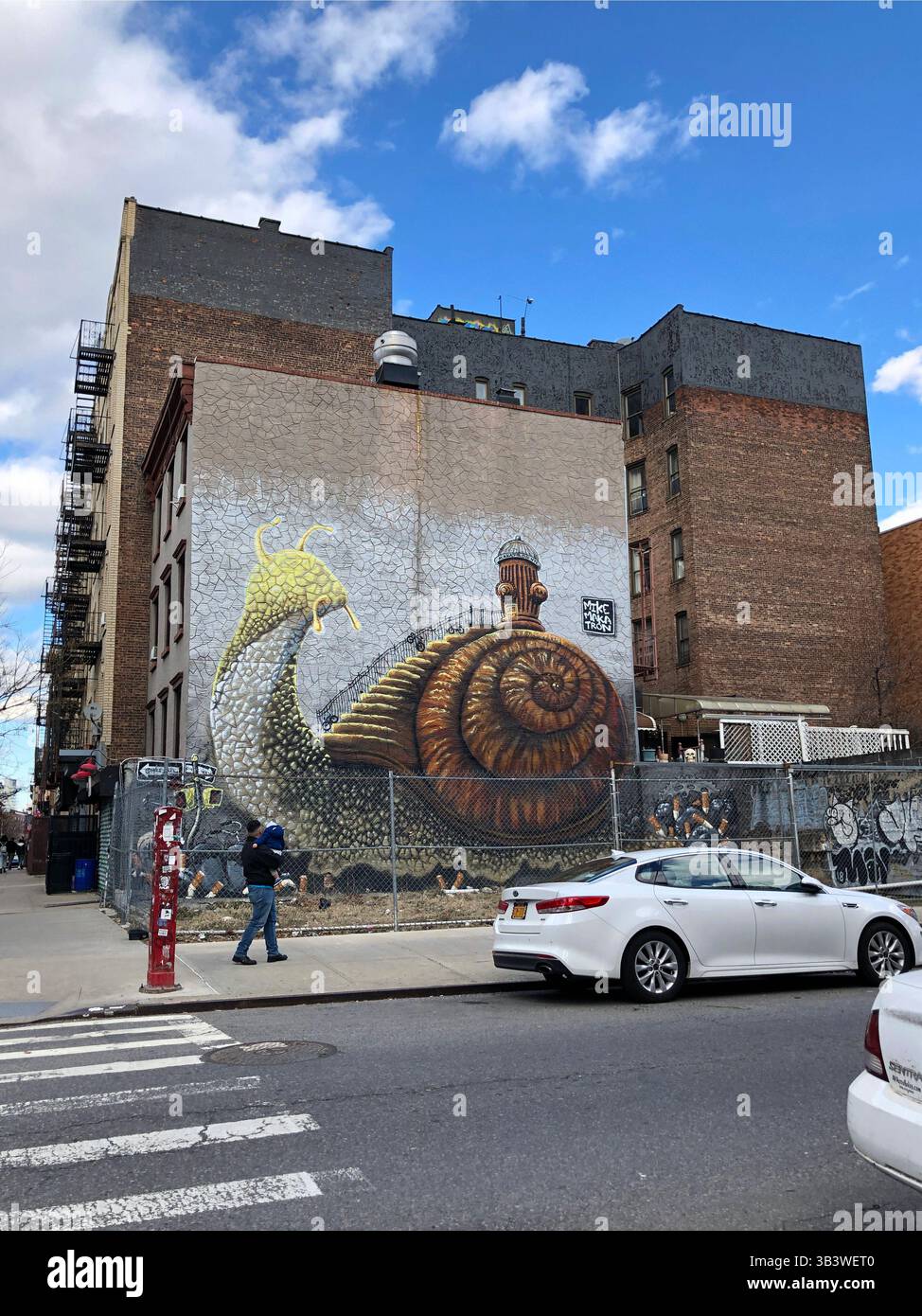 A classic day unfolds as commuters move past cafes and signs in the ...