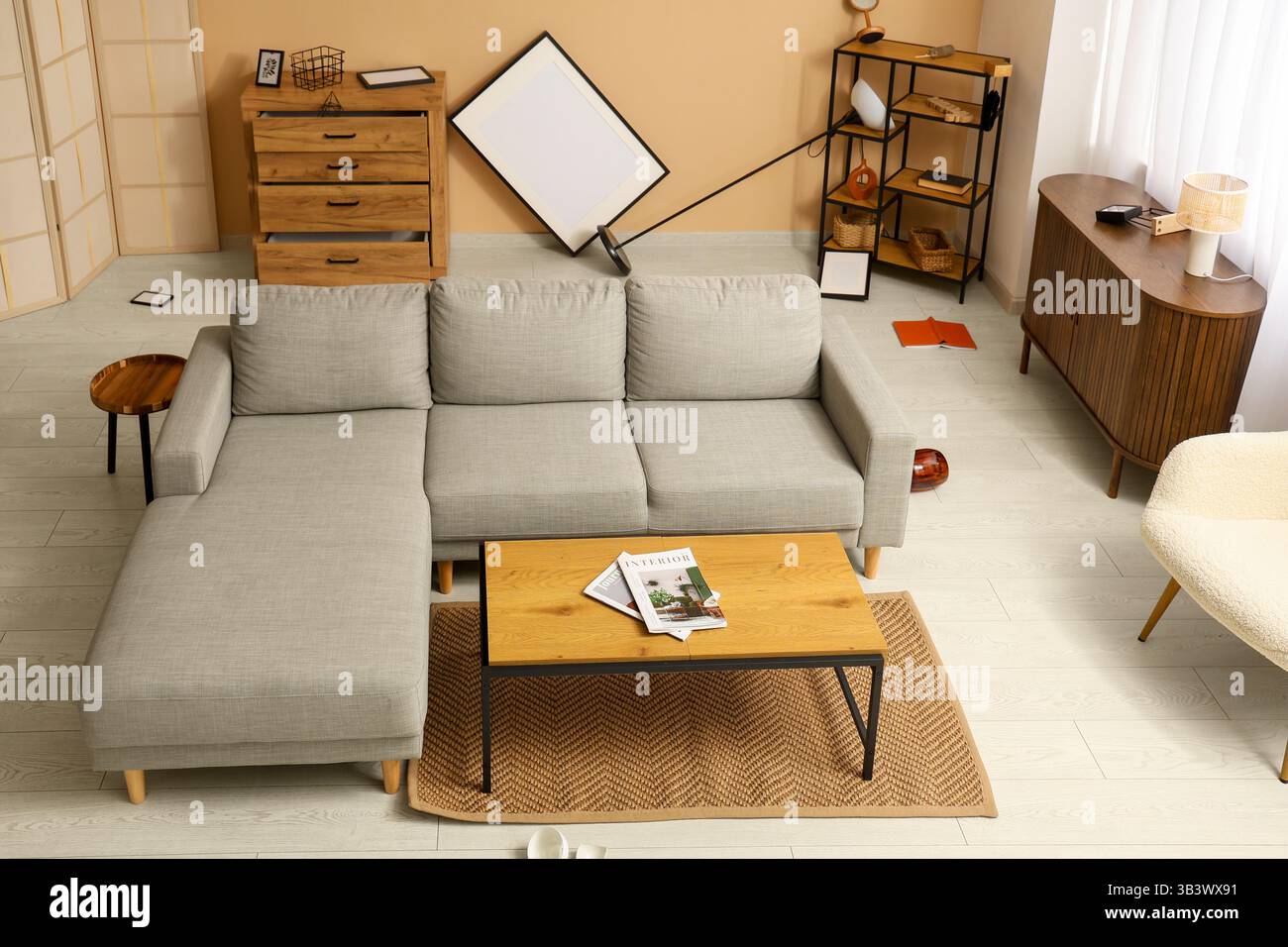 Interior of messy living room with grey sofa, coffee table and ...