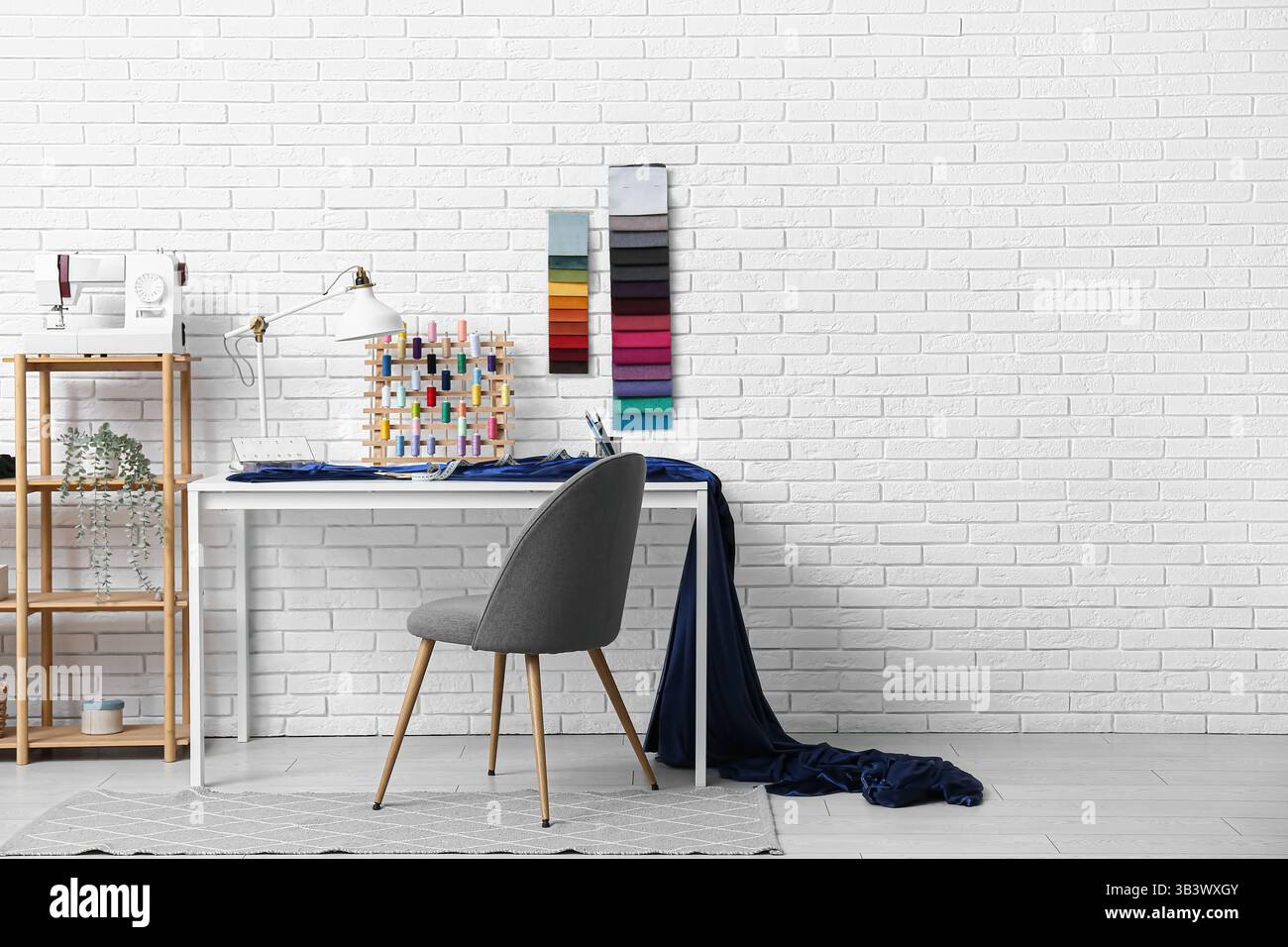Interior of atelier with tailor's workplace and shelf unit Stock Photo ...