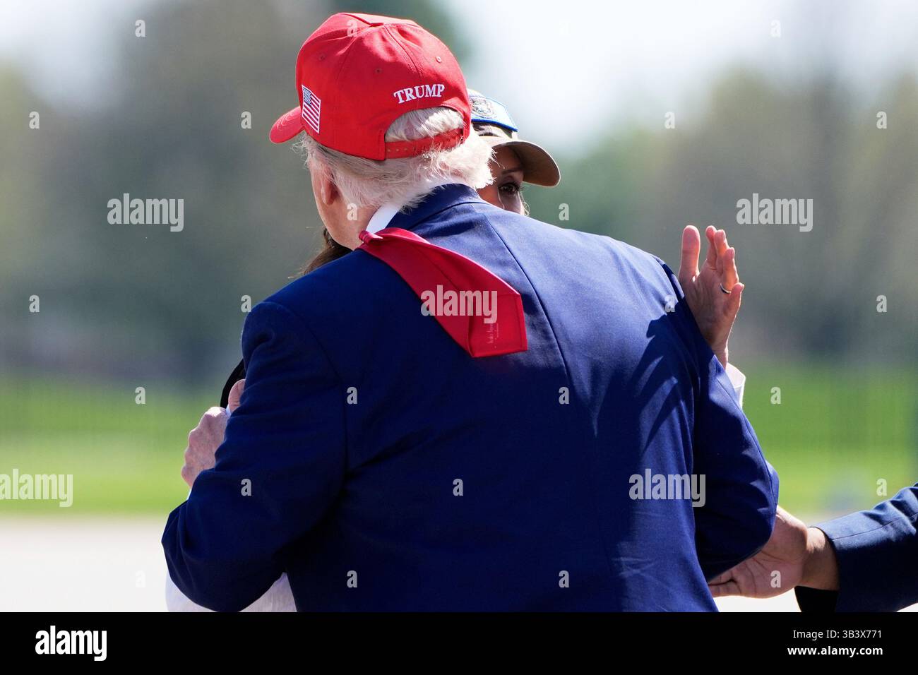President Donald Trump greets Michigan Gov. Gretchen Whitmer as he arrives on Air Force One at ...