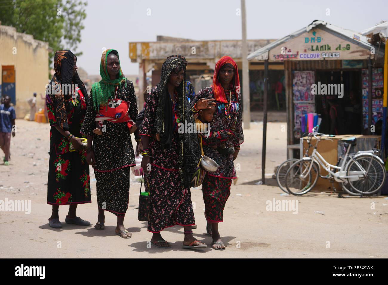 Women return home from a market in Dikwa, north east Nigeria, Tuesday ...