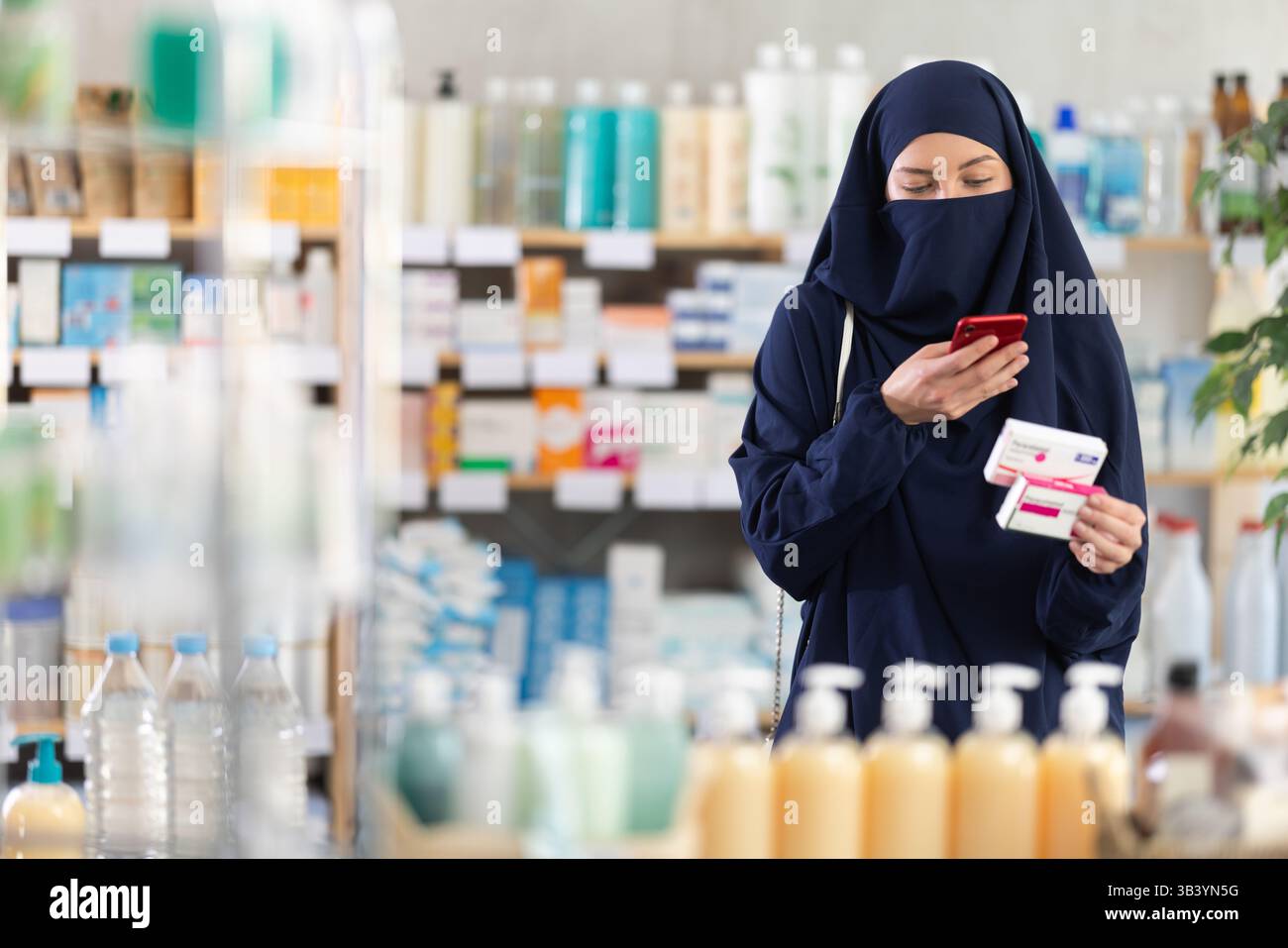 Young woman in hijab scanning qr code of paracetamol Stock Photo - Alamy