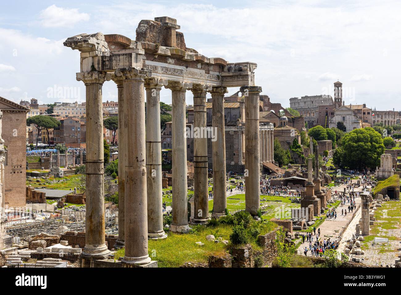 Towering columns showcase the grandeur of ancient Rome, surrounded by lush greenery and a ...