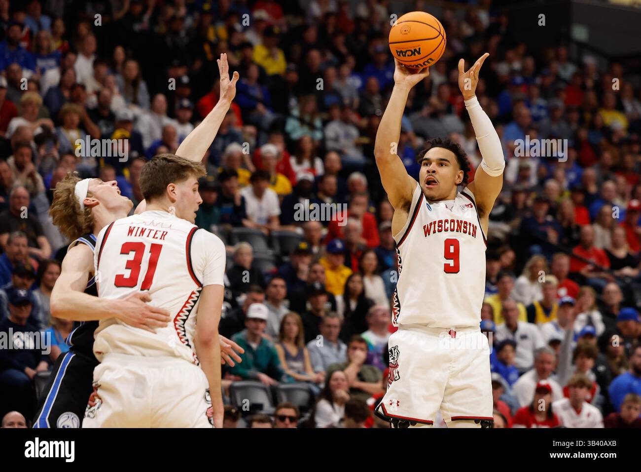 Denver, CO, USA. 22nd Mar, 2025. Wisconsin Badgers guard John Tonje (9 ...