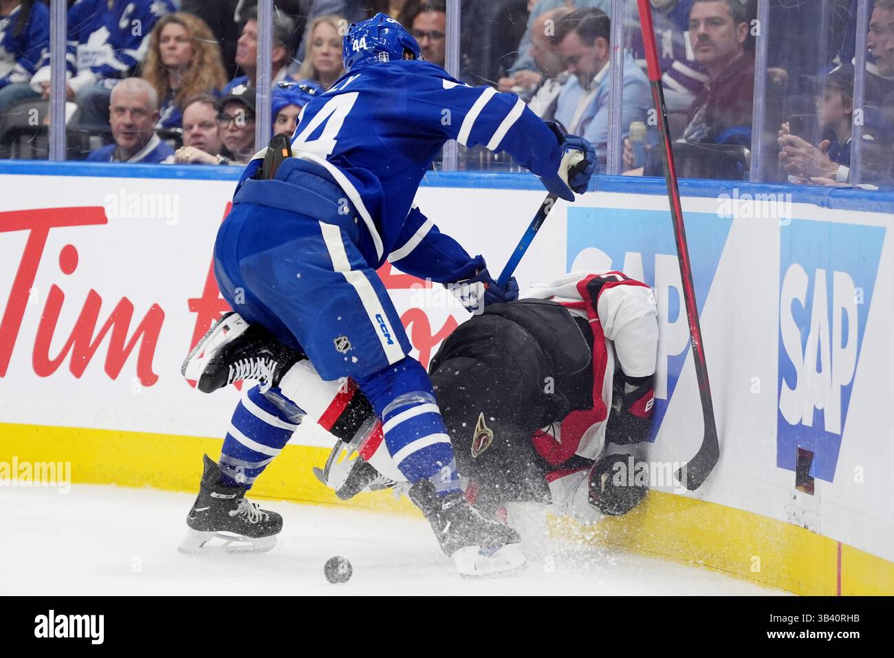 Toronto Maple Leafs' Morgan Rielly (44) checks Ottawa Senators' Thomas ...