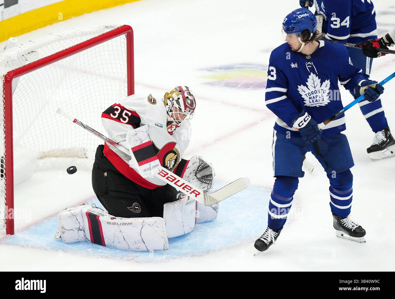 Toronto Maple Leafs' Matthew Knies (23) tries to screen Ottawa Senators ...